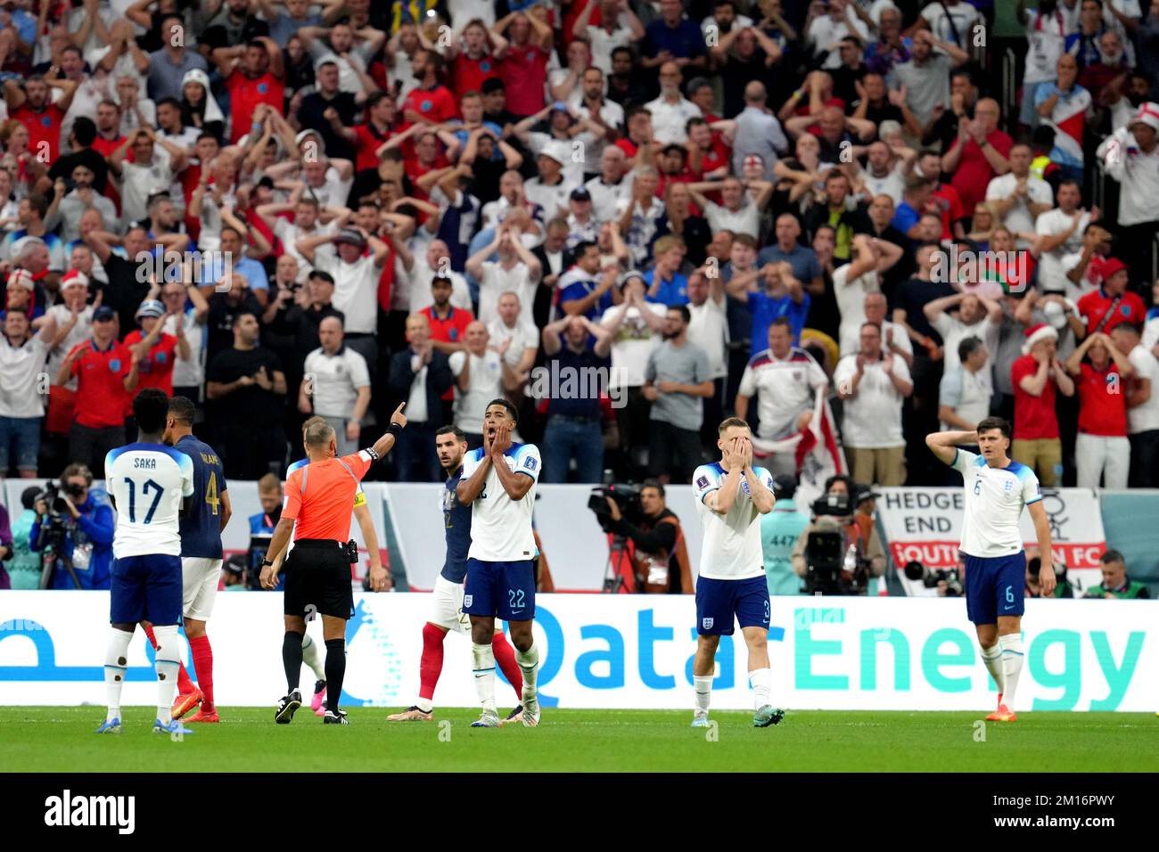 England's Jude Bellingham (centre) is dejected after his shot is saved ...