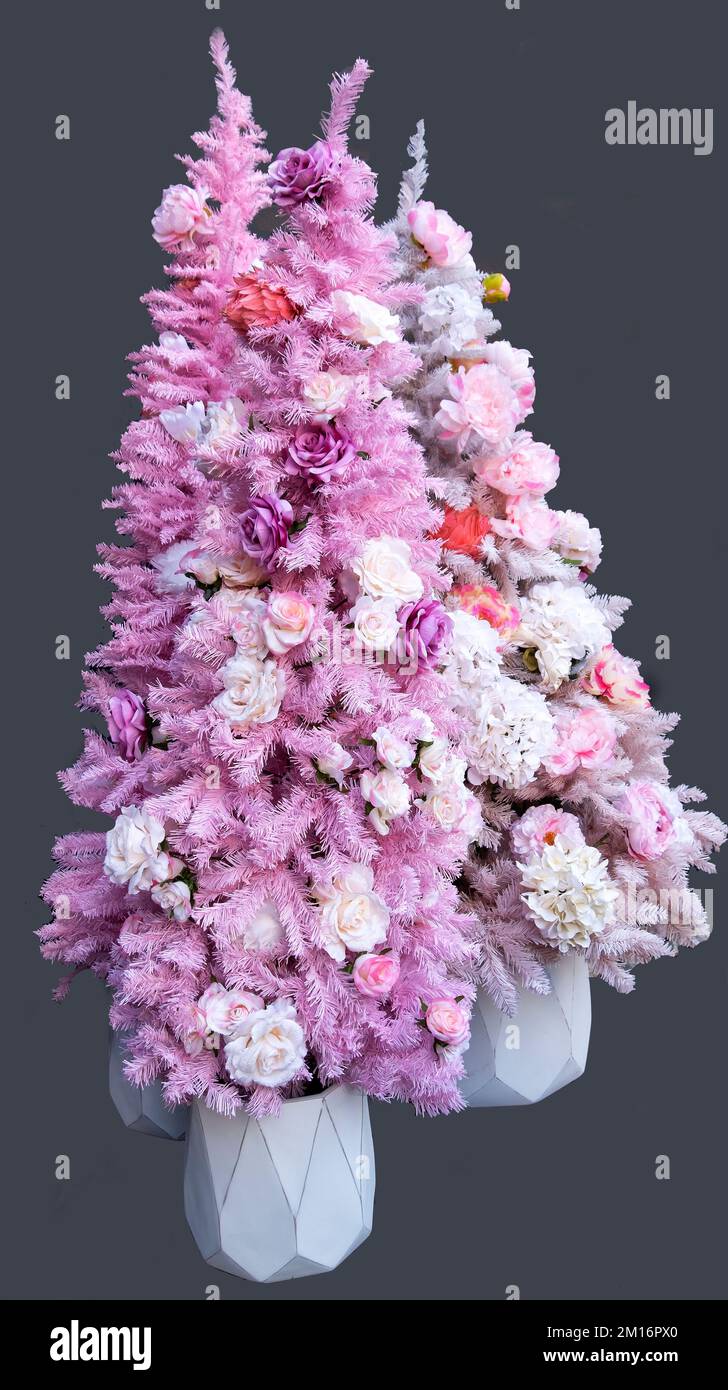 Christmas trees mad of mauve, pink and white flowers and branches ...