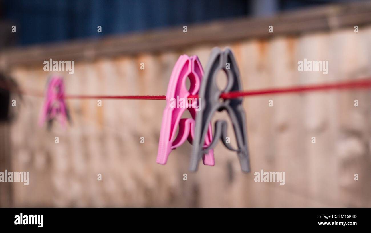 Close-up of isolated coloured pegs on a laundry line Stock Photo - Alamy