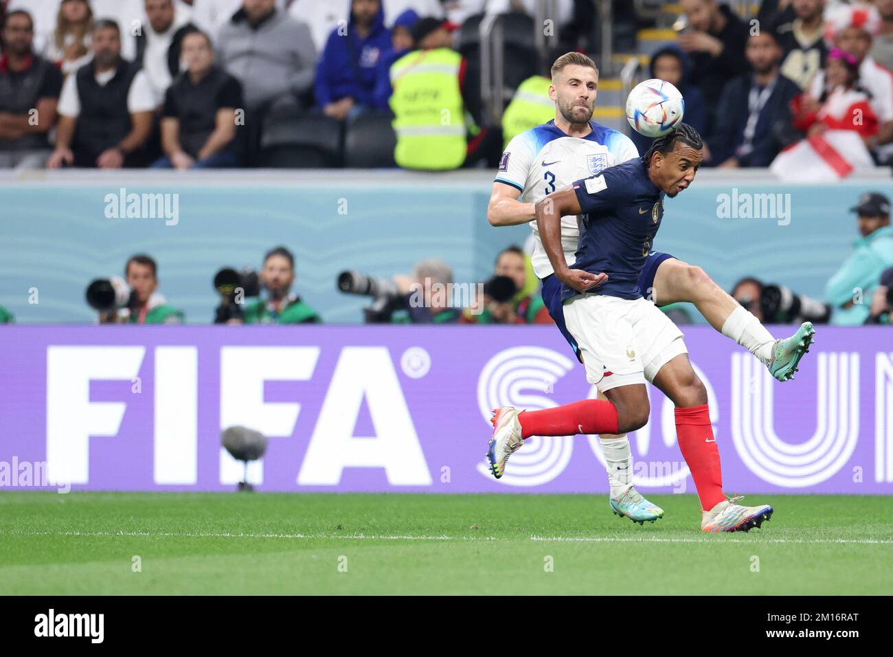 Al Khor, Qatar. 10th Dec, 2022. Jules Kounde (R) of France vies with ...