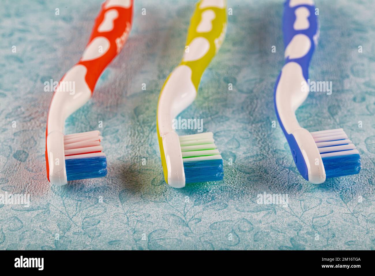 Plastic toothbrushes on the color background Stock Photo - Alamy
