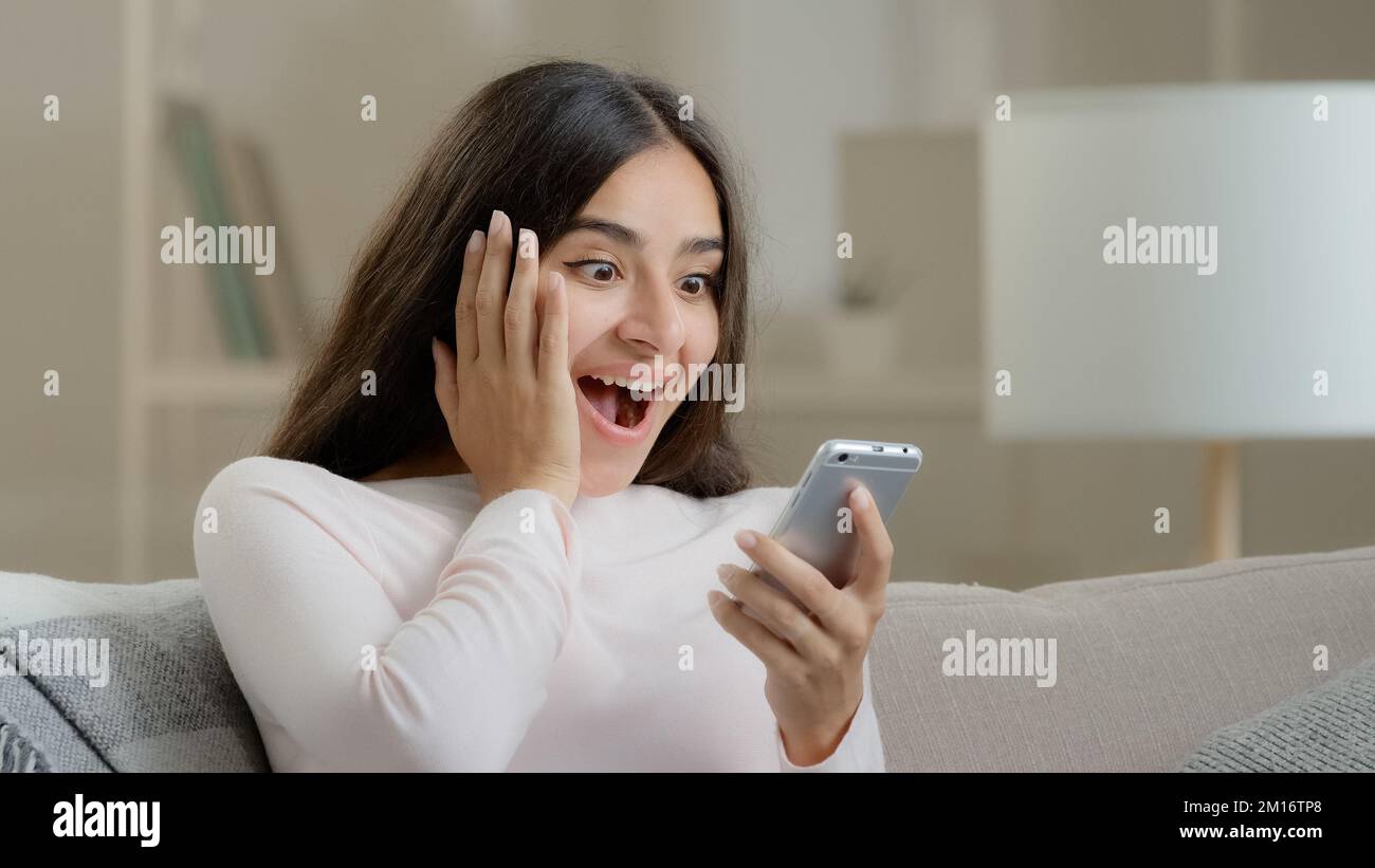 Satisfied happy client female look at phone screen win internet auction ...