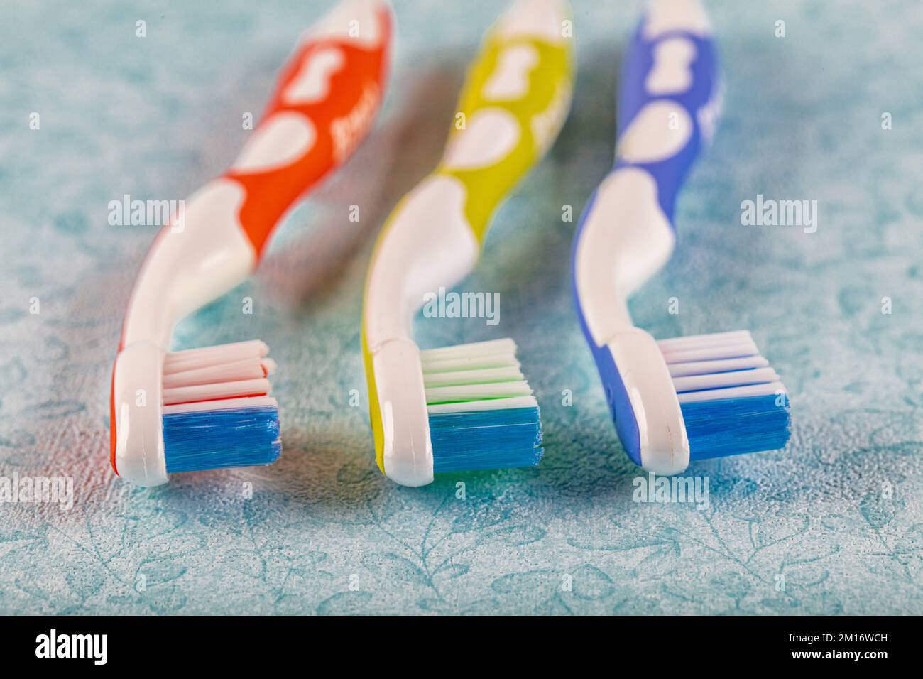 Plastic toothbrushes on the color background Stock Photo - Alamy
