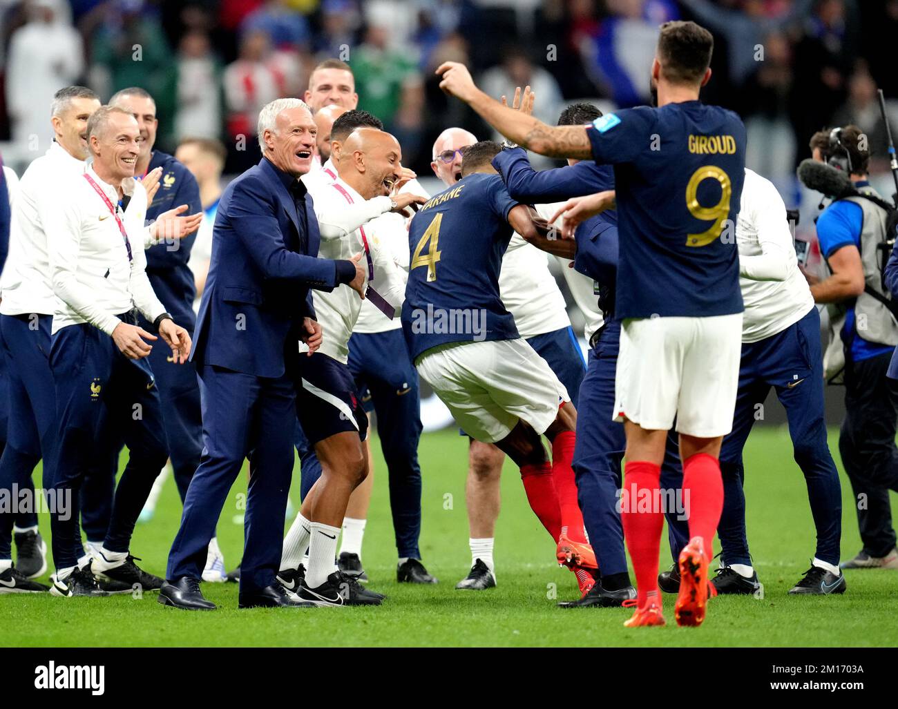 France manager Didier Deschamps (centre) celebrates alongside Raphael ...