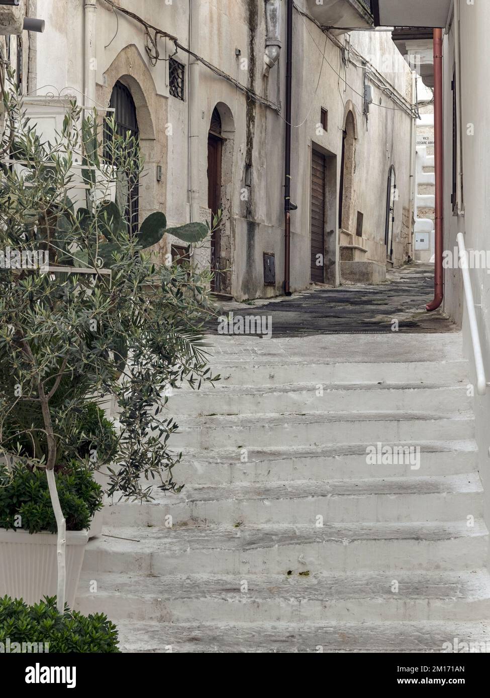 OSTUNI, ITALY - OCTOBER 18, 2022: View up street in the old town with ...