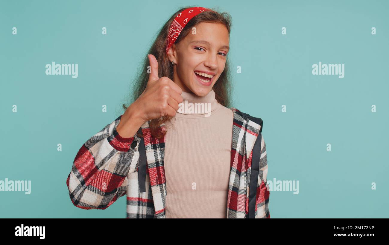 Like. Happy young teenager child girl kid looking approvingly at camera ...