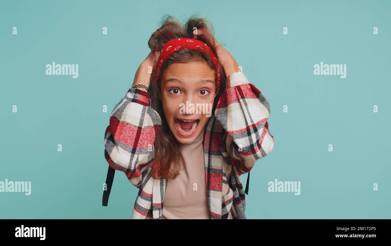 Young depressed school girl in shirt screams, yells from stress tension ...