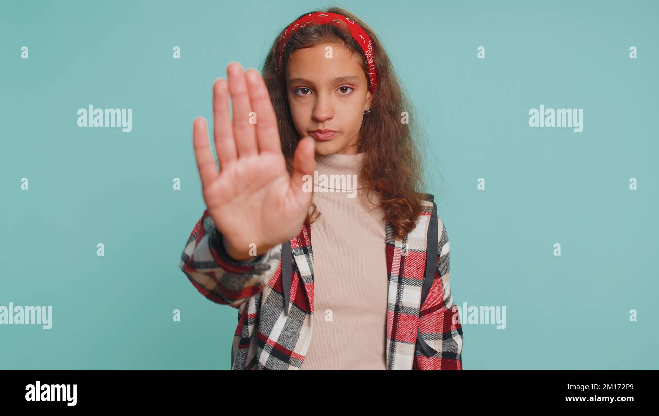 Stop gesture. Angry young preteen child girl kid say No hold palm ...