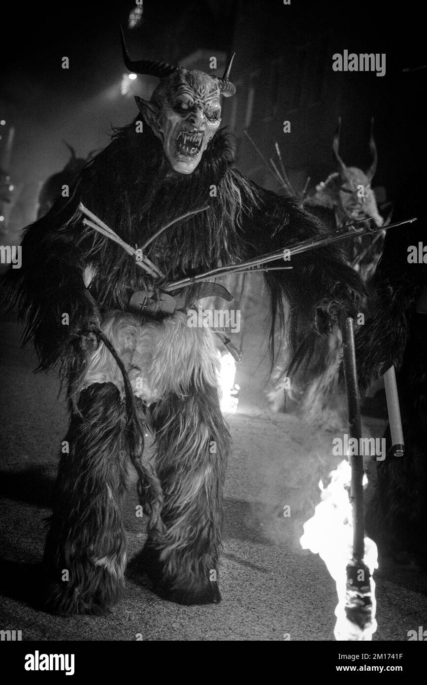 Masked devil beasts parade through the village scaring the crowd while ...