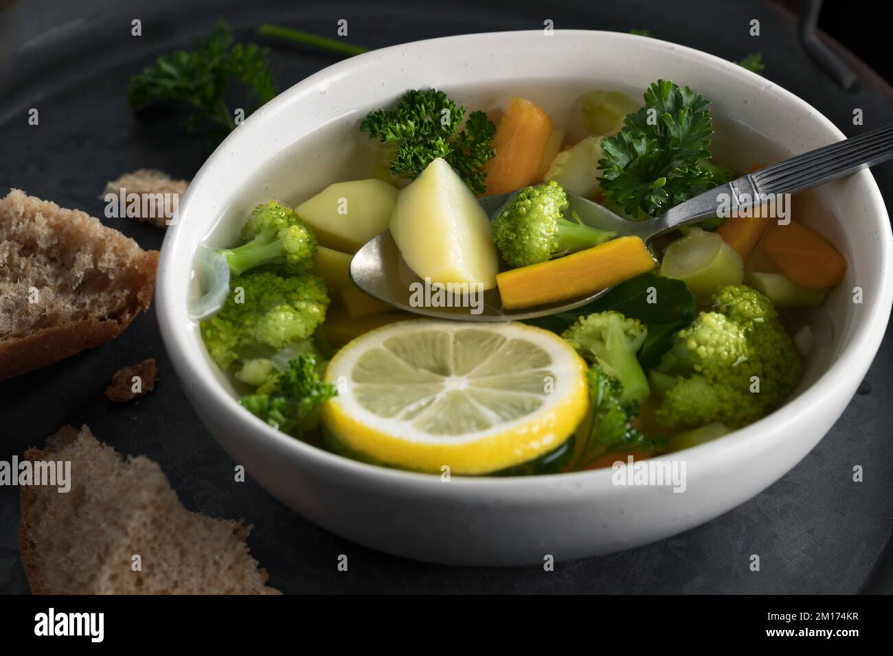 Vegetarian vegetable soup with carrots, broccoli and parsley in a light ...