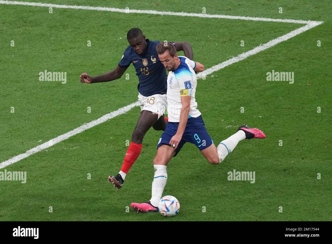 Al Khor, Qatar. 10th Dec, 2022. Harry Kane (R) of England vies with ...