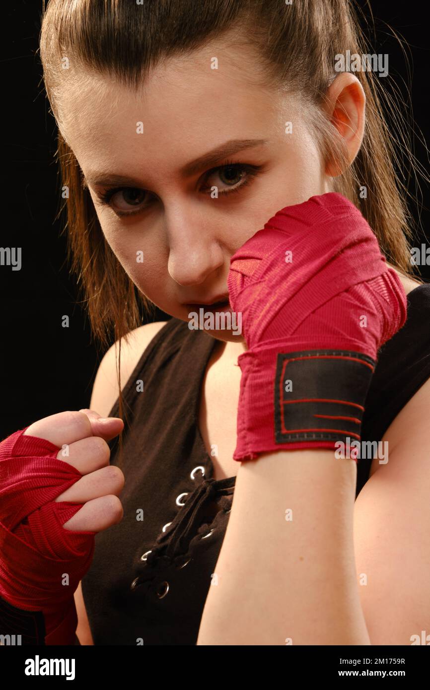Muay Thai female boxer in attack pose. Fitness young woman boxing ...