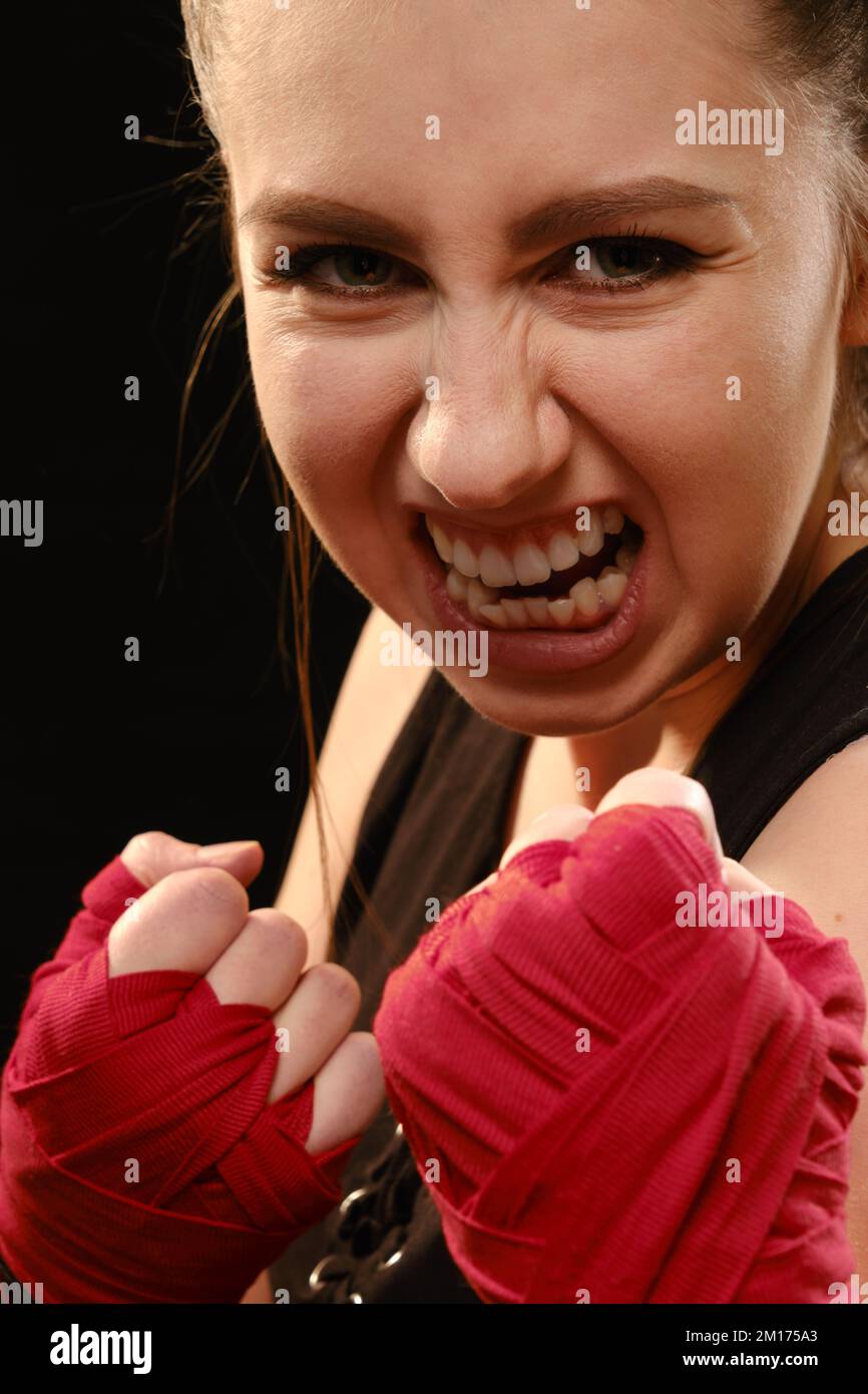 Muay Thai Female Boxer In Attack Pose Fitness Young Woman Boxing Training On Black Background
