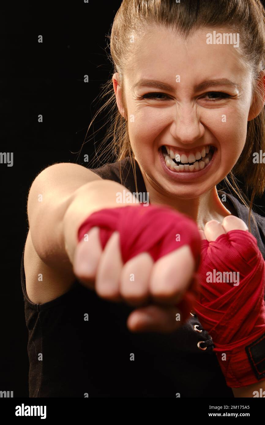 Muay Thai female boxer in attack pose. Fitness young woman boxing ...