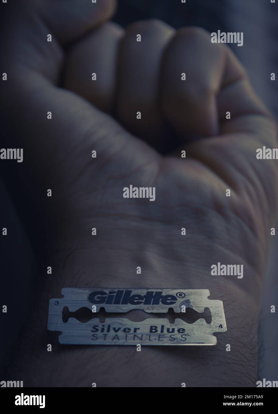 A closeup shot of a blade on a man's hand Stock Photo - Alamy