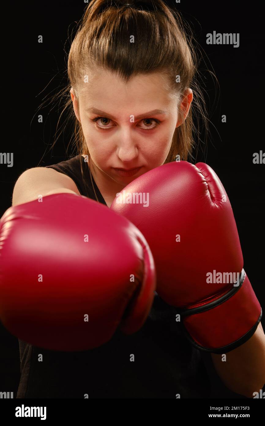 Muay Thai female boxer in attack pose. Fitness young woman boxing ...