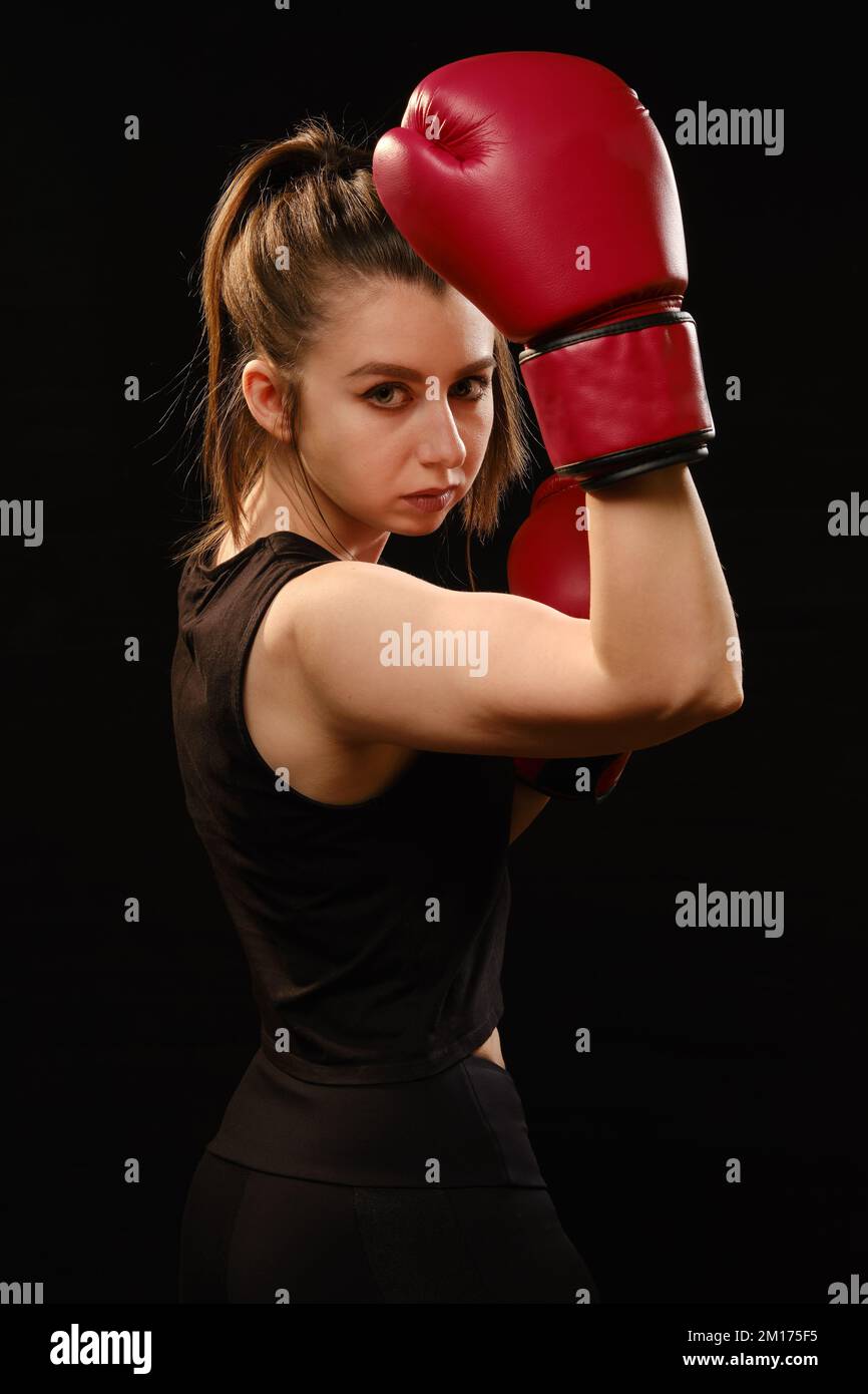 Muay Thai female boxer in attack pose. Fitness young woman boxing ...
