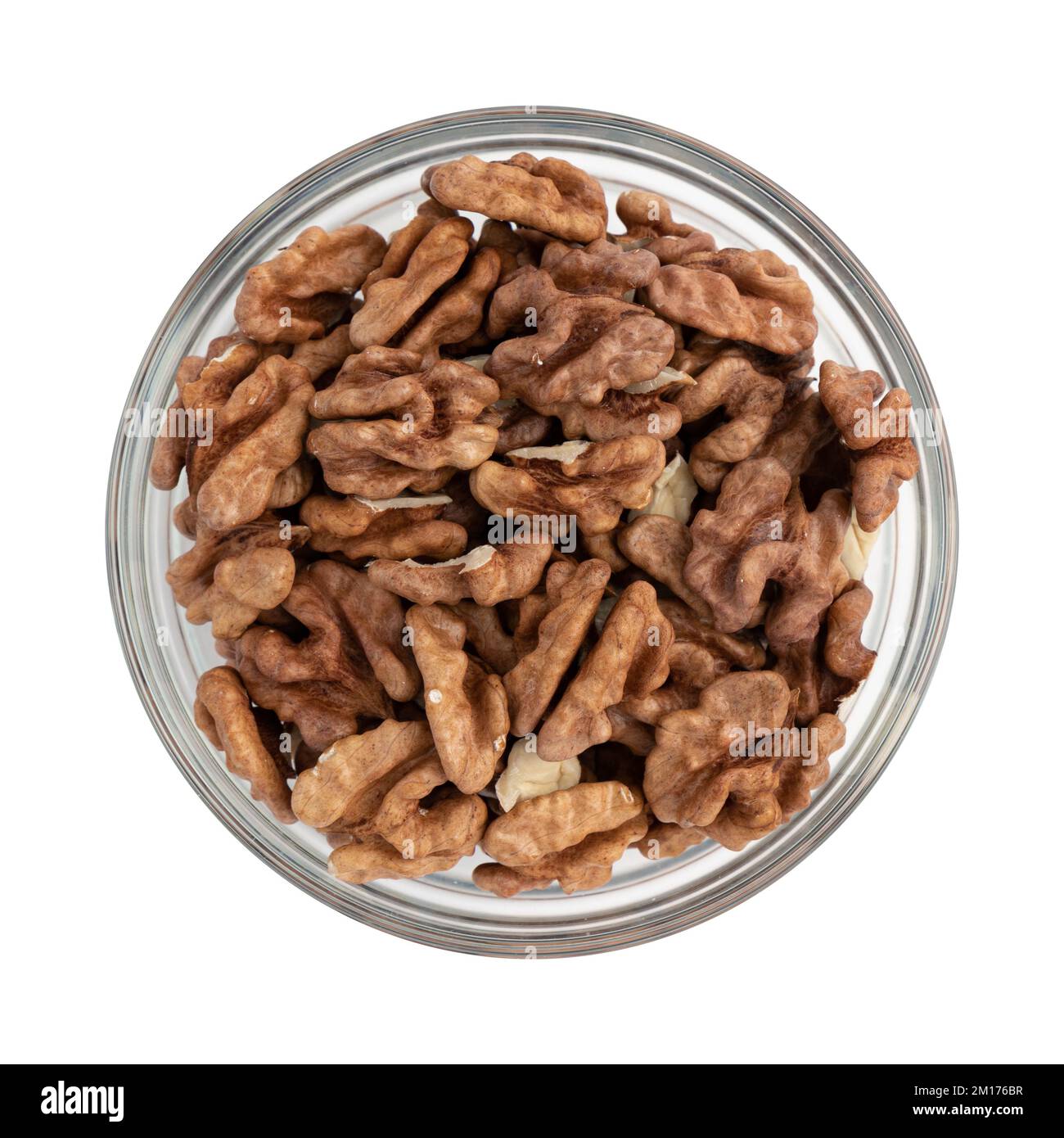 peeled walnuts in glass bowl isolated on white background, vegetarian ...