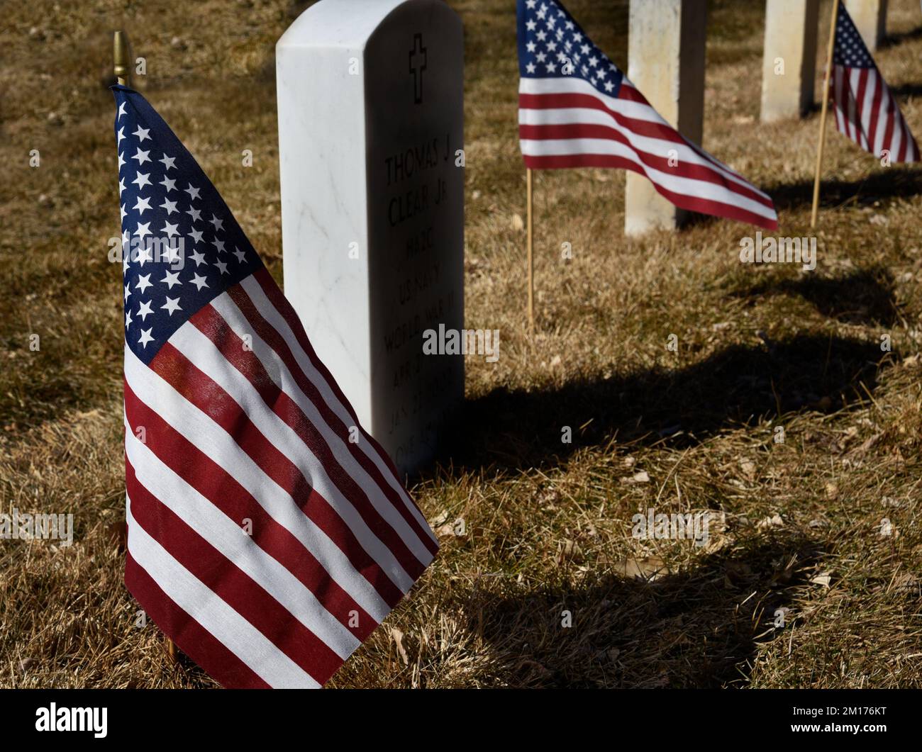 Small American flags fly beside the graves of US military veterans ...