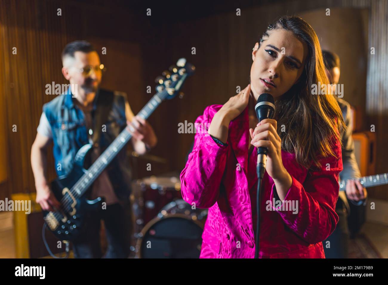 medium shot of a music band playing on repetition in the recording ...