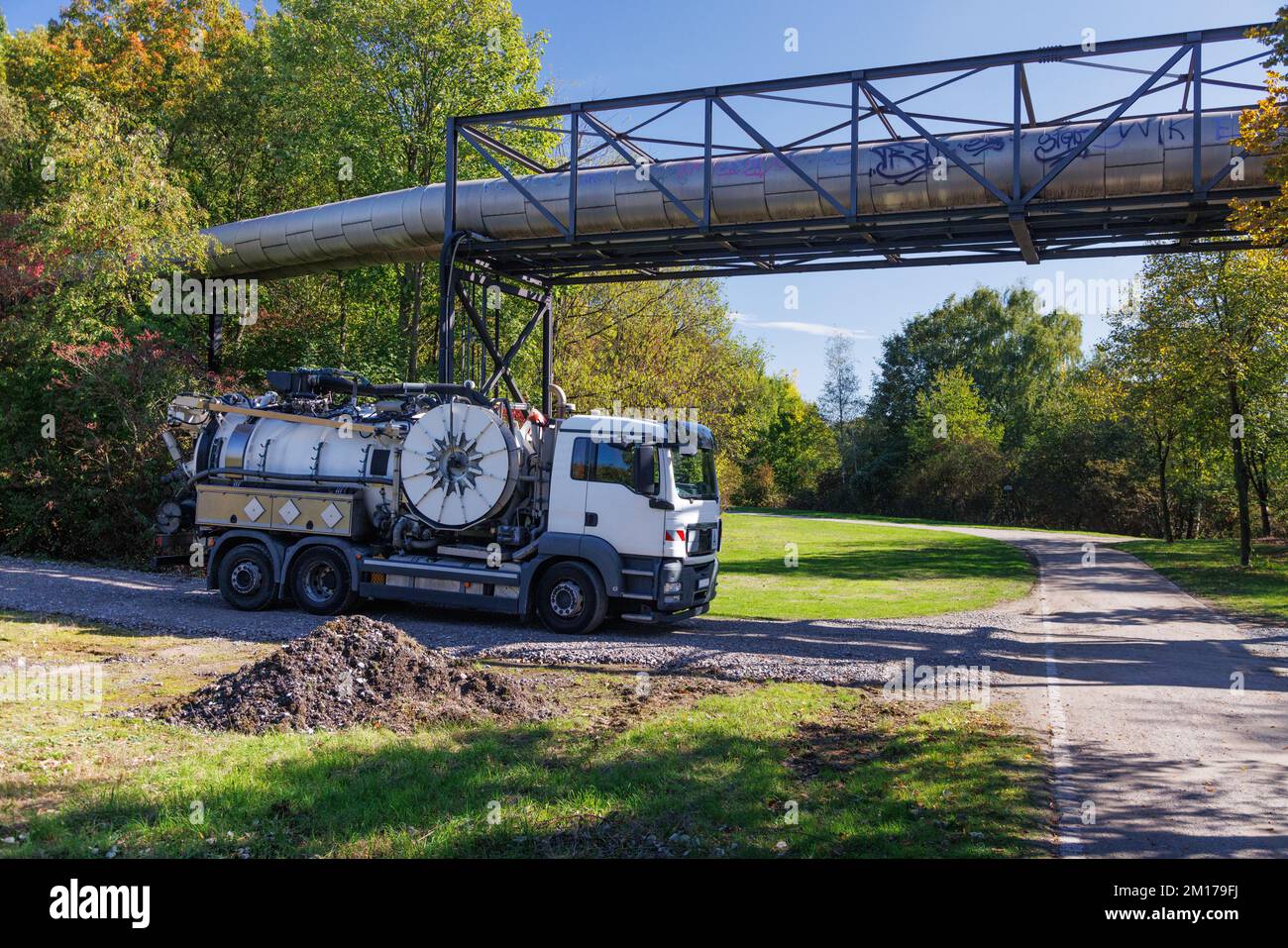 Vacuum and street sewer cleaner truck in the green park. Truck ...