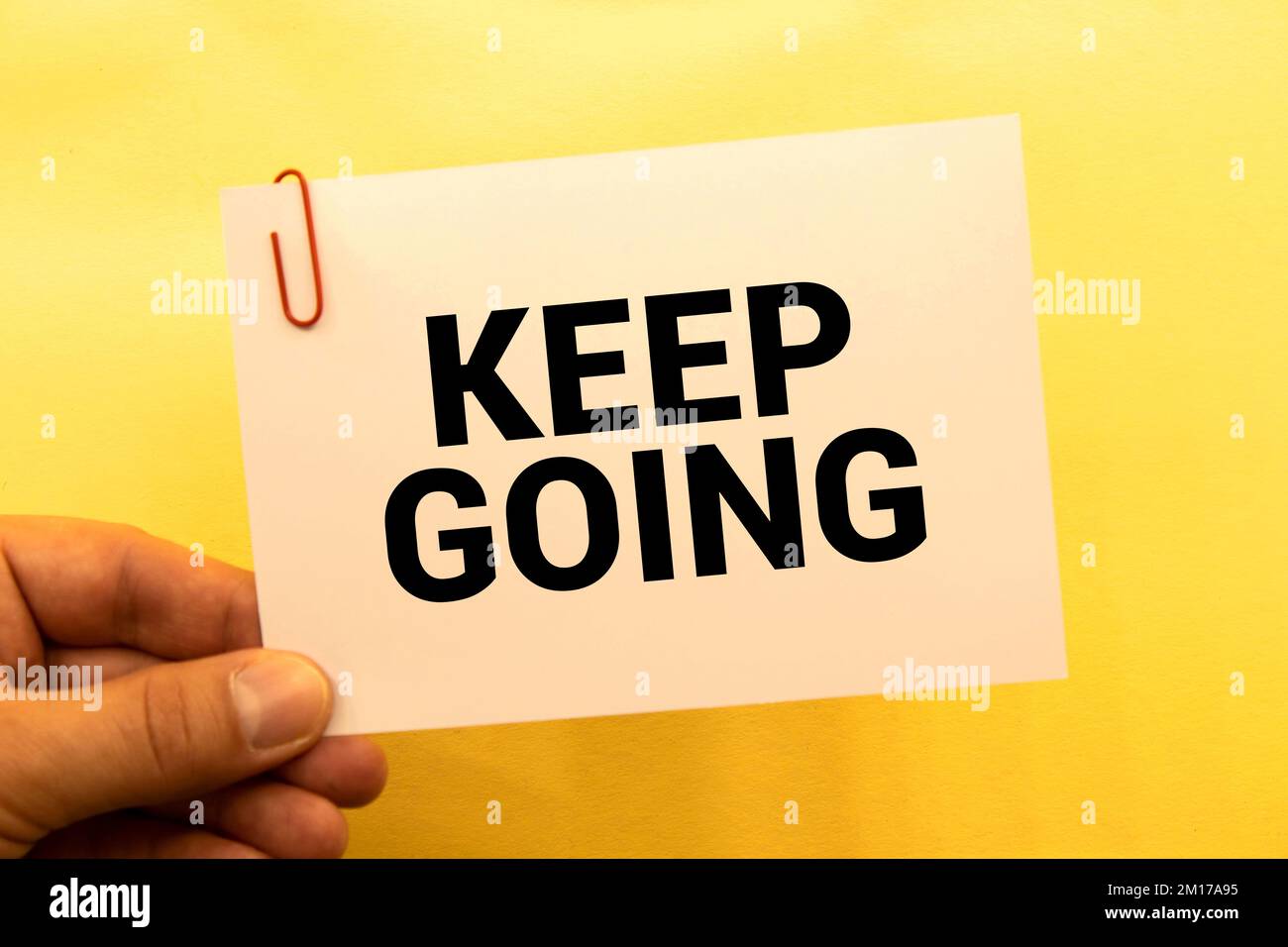 On a light pink background - a craft envelope. It has a white sheet of ...