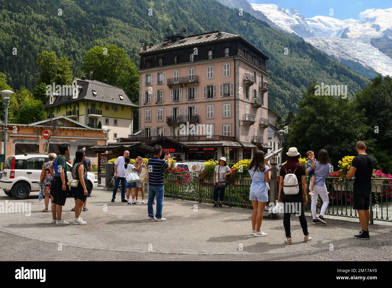 Tourists taking pictures of the Mont Blanc from a bridge over the Arve ...
