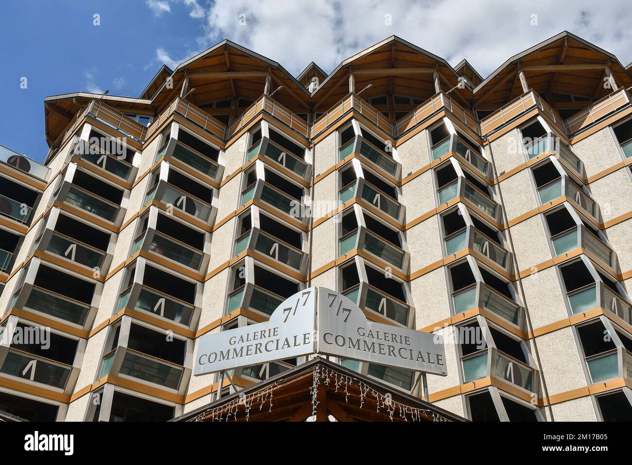 Low-angle view of the façade of the Alpina Hotel with the sign of the ...