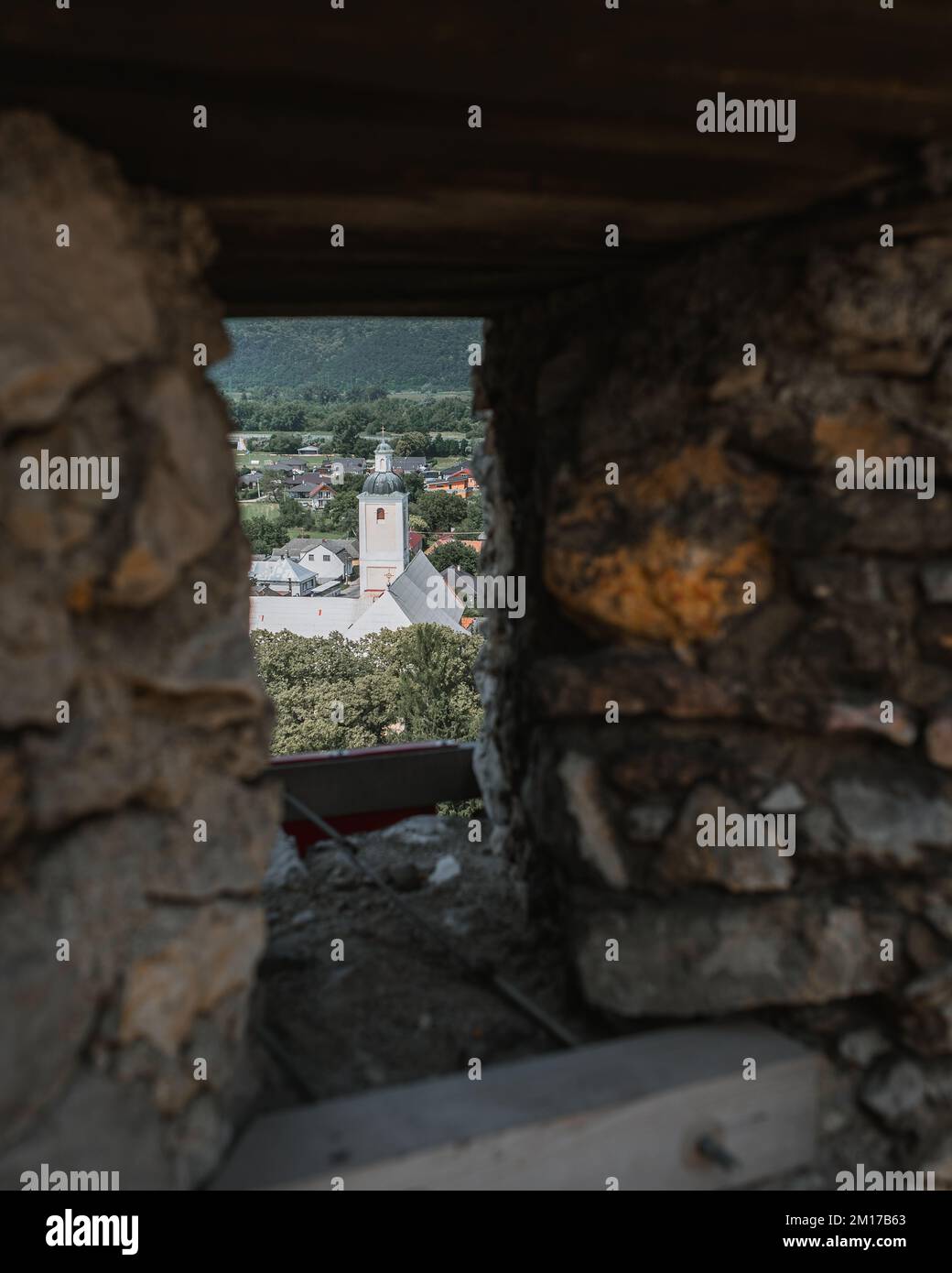 A Beckov village view from a small stone window trees and buildings ...