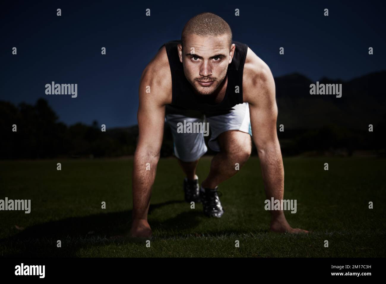 In it to win it. A young man in the starting position for a race Stock ...