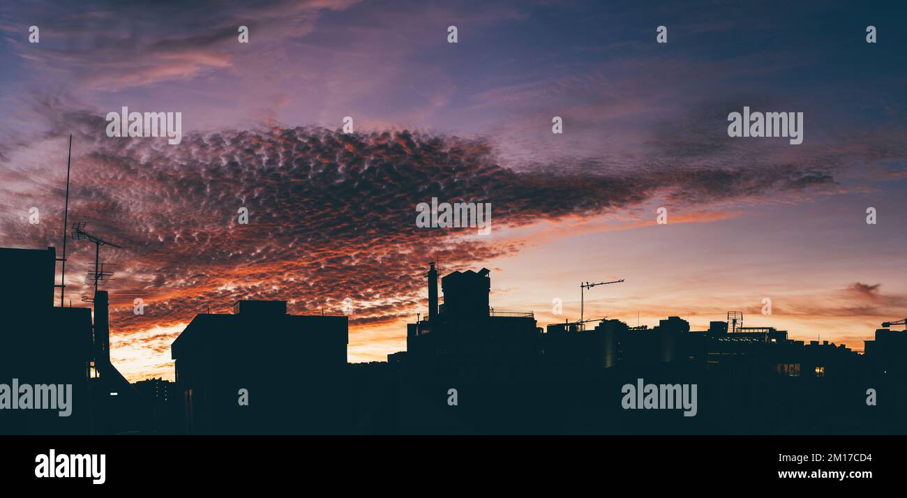 A dramatic evening sunset creates an atmospheric sky in shades of blue ...