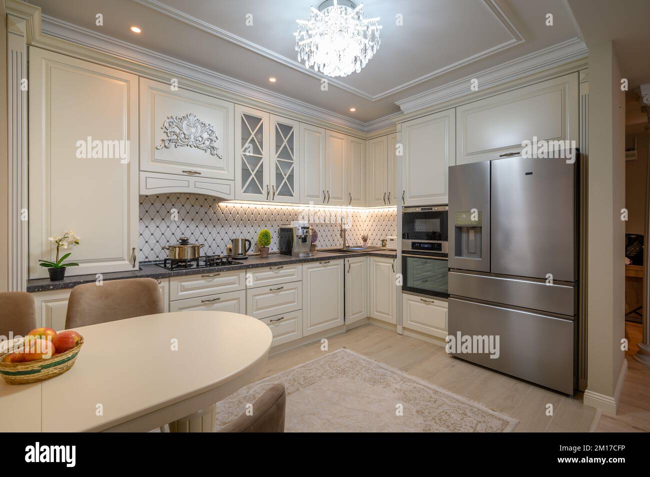 Open-concept kitchen with a beige color scheme and classic design ...