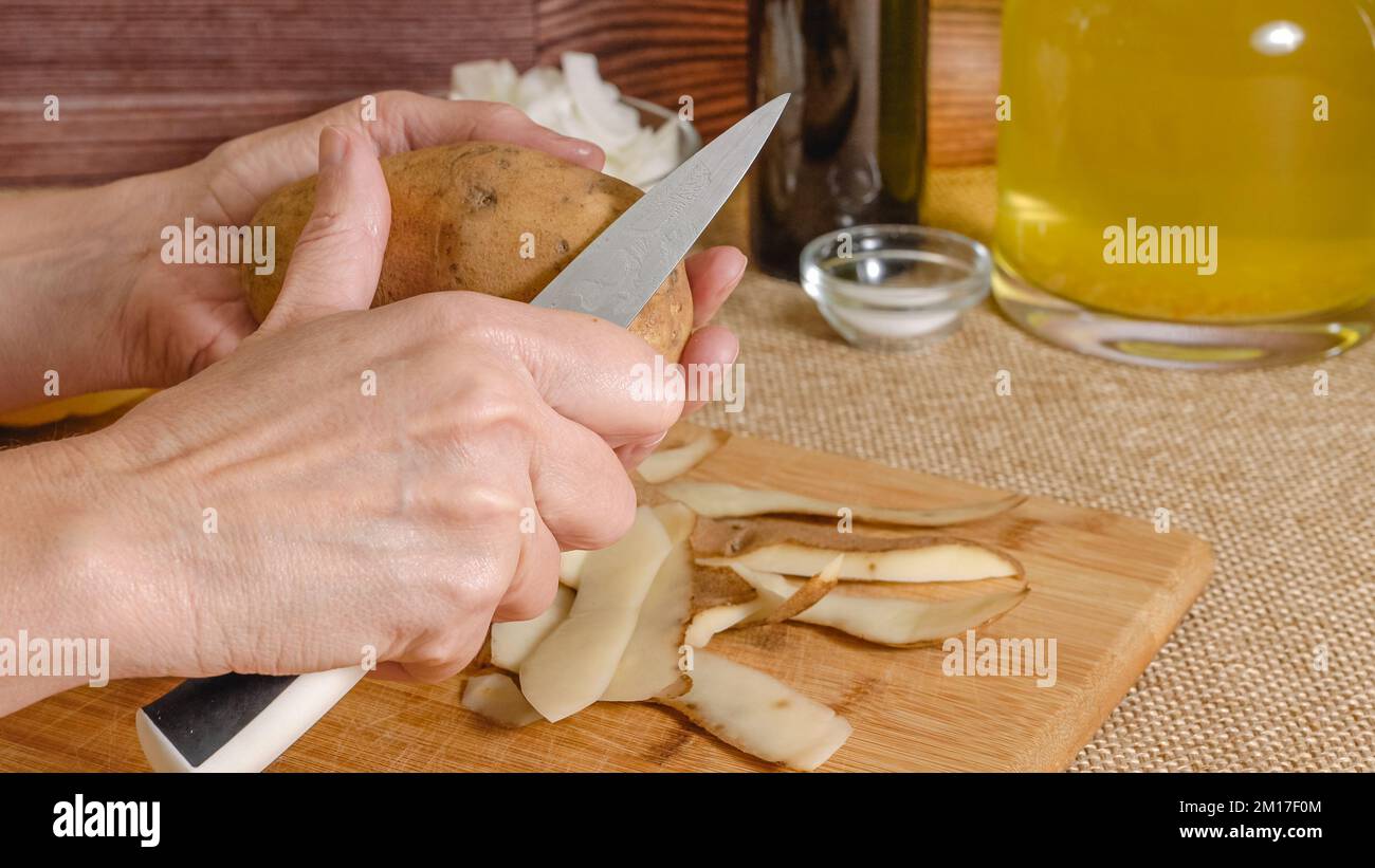 Peeling and cutting potatoes. Vegetables soup recipe. Fresh raw ...