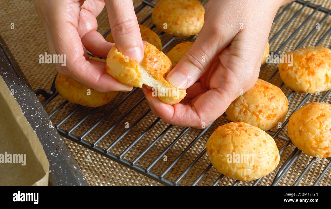 Traditional Brazilian cheese bread balls on cooling rack close-up on ...
