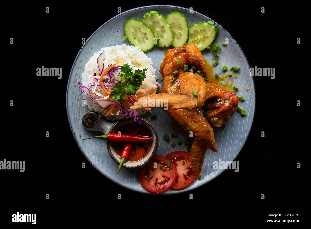 Roasted chicken wing in Vietnamese style with rice, vegetables and ...