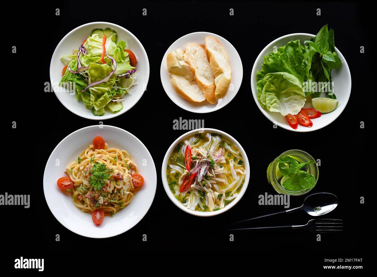 Lunch set made of chicken soup, salad, banh mi,pasta carbonara ...
