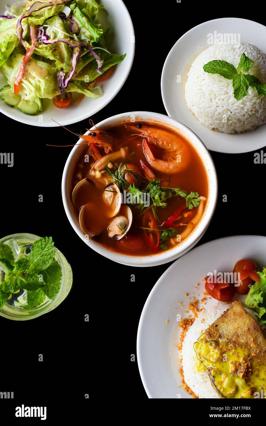 Lunch set made of tom yum soup, salad, grilled basa fish, rice ...