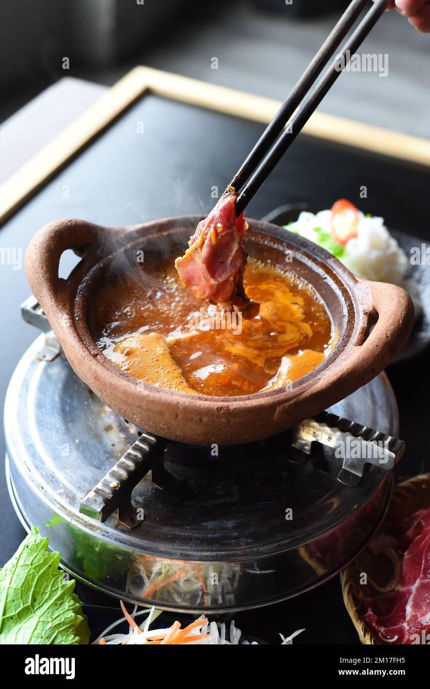 Traditional korean hot pot dish with beef and spicy bouillon on black ...