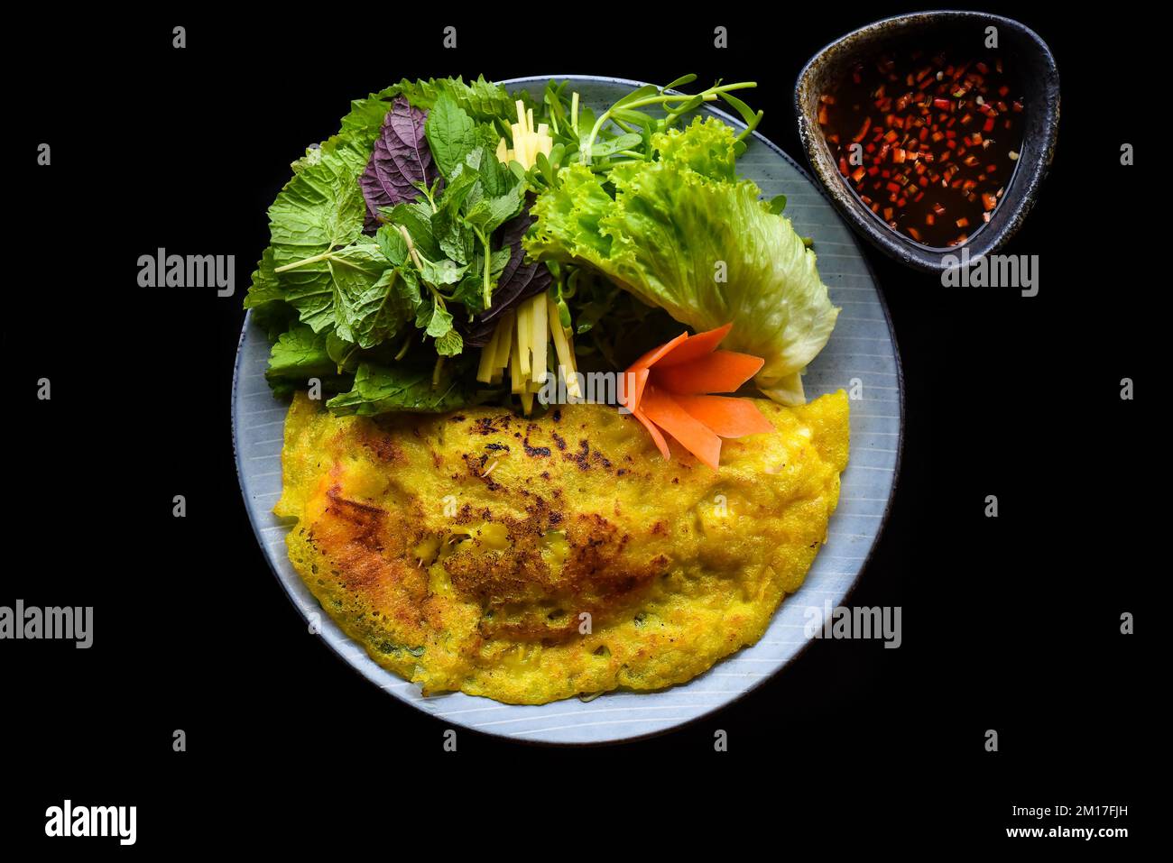 Vietnamese pancake with sea food on black background side view Stock ...