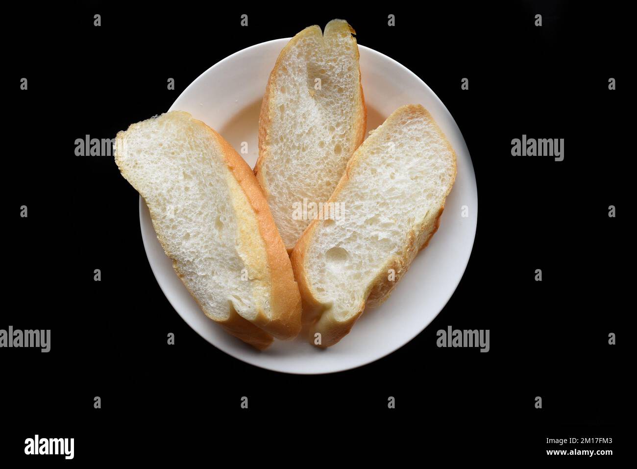 Sliced Vietnamese traditional Banh Mi baguette on black background ...