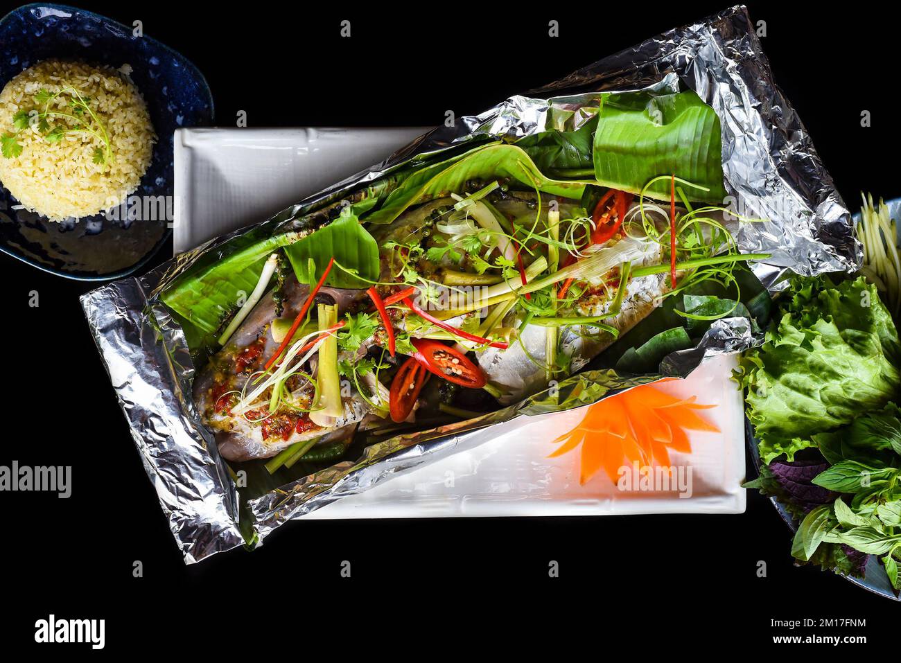 Parrot fish grilled in Vietnamese style with vegetables and white rice ...