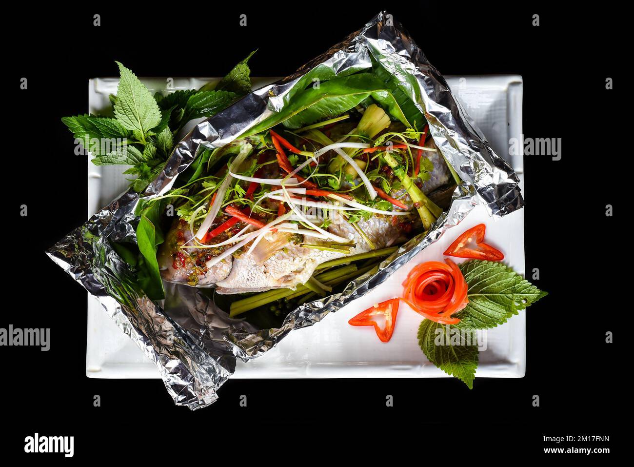 Grilled red perch with vegetables greens and white rice isolated on ...