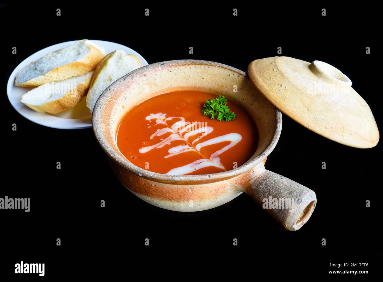 Tomato Cream Soup isolated on black background side view Stock Photo ...