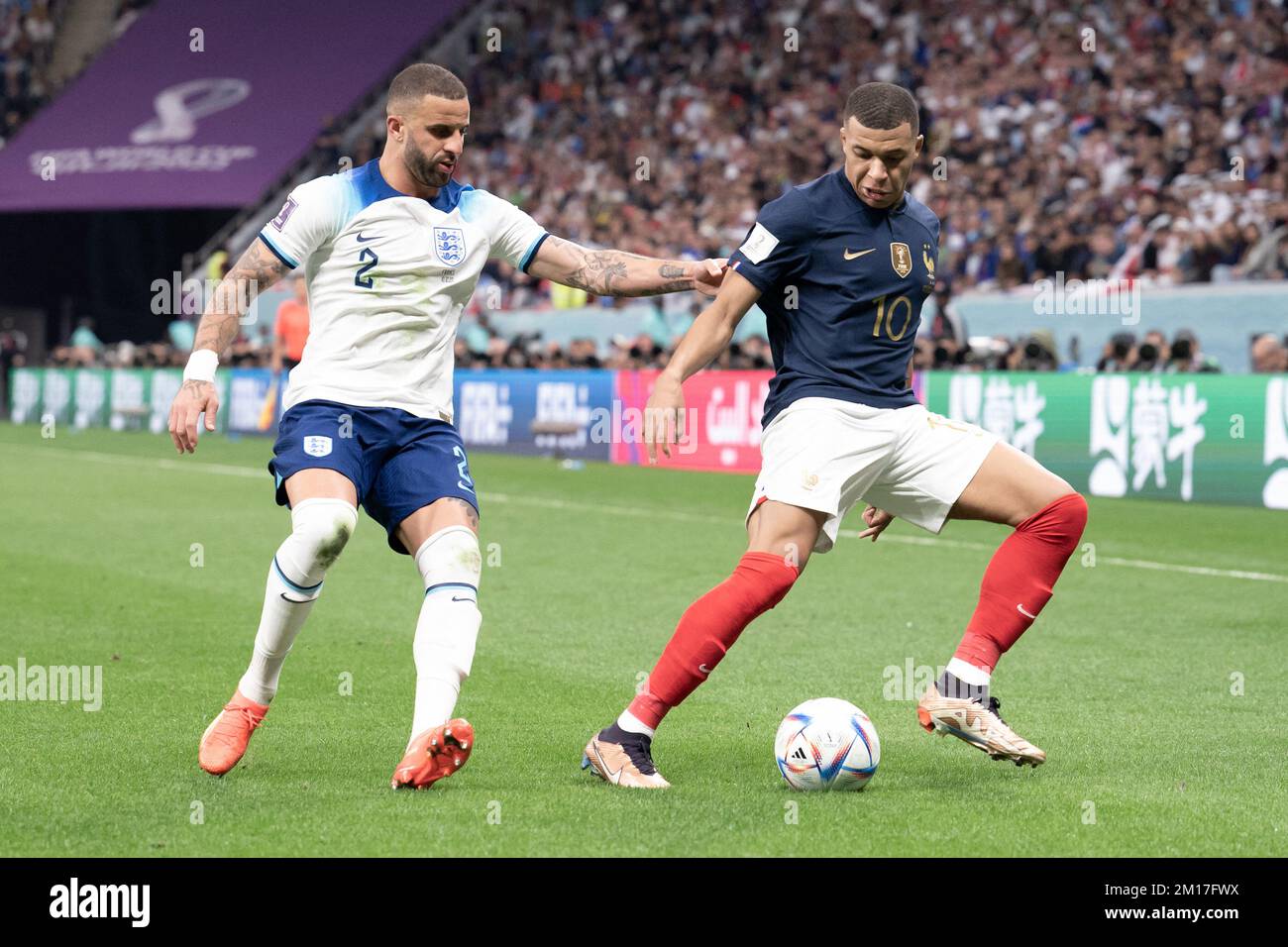 Kylian Mbappe of France and Kyle Walker of England in action during the ...
