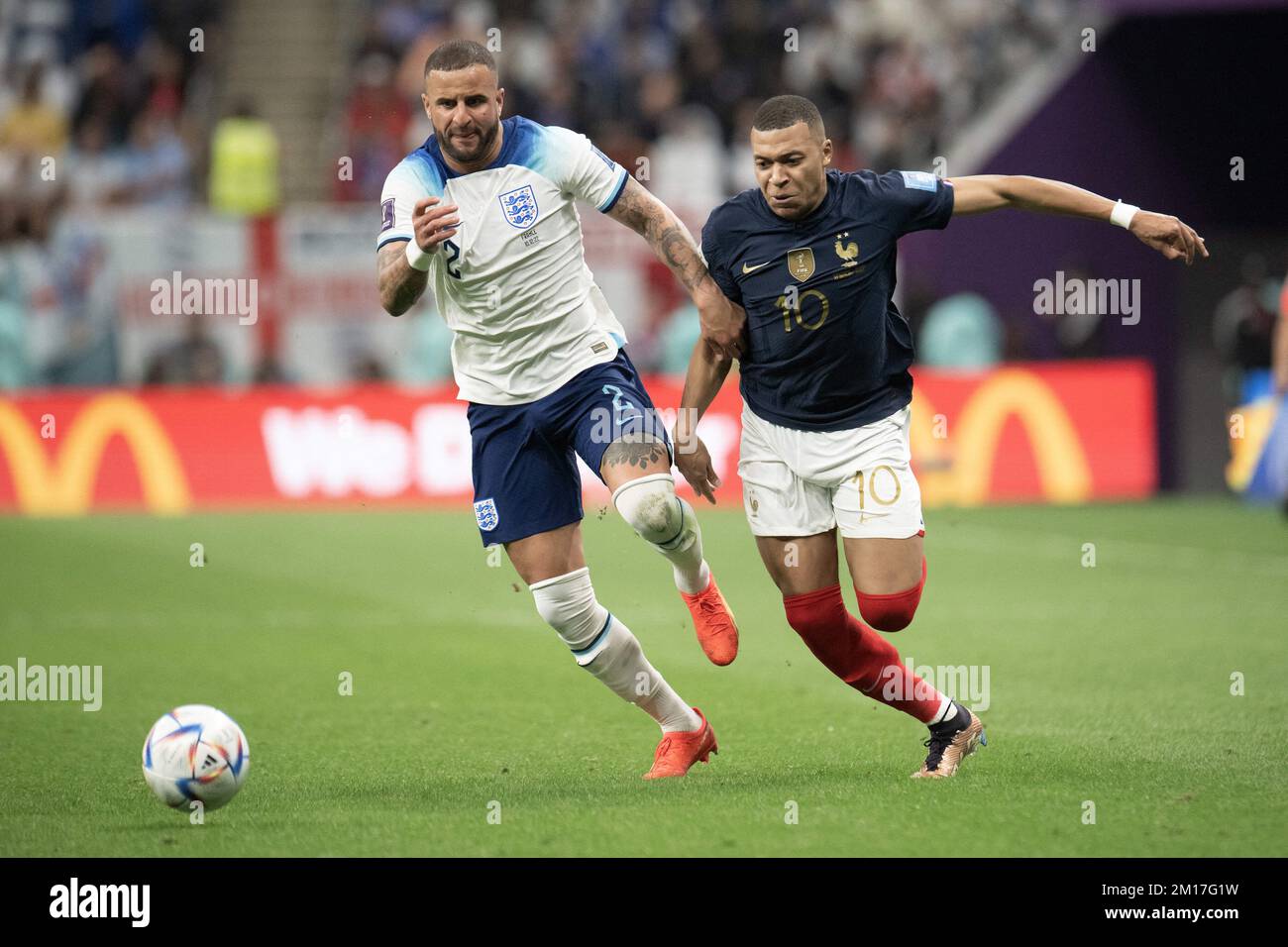 Kylian Mbappe of France and Kyle Walker of England in action during the ...