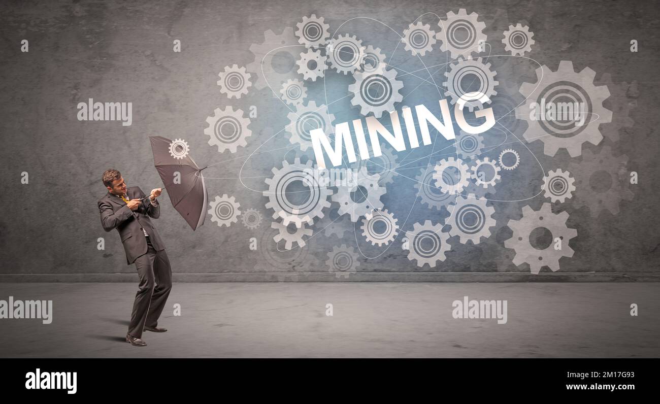 Businessman defending with umbrella concept Stock Photo - Alamy