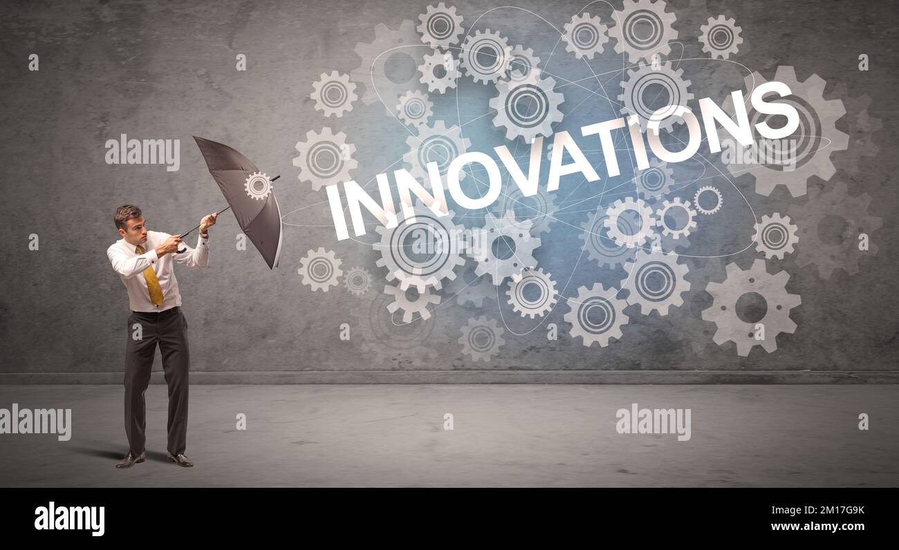 Businessman defending with umbrella concept Stock Photo - Alamy