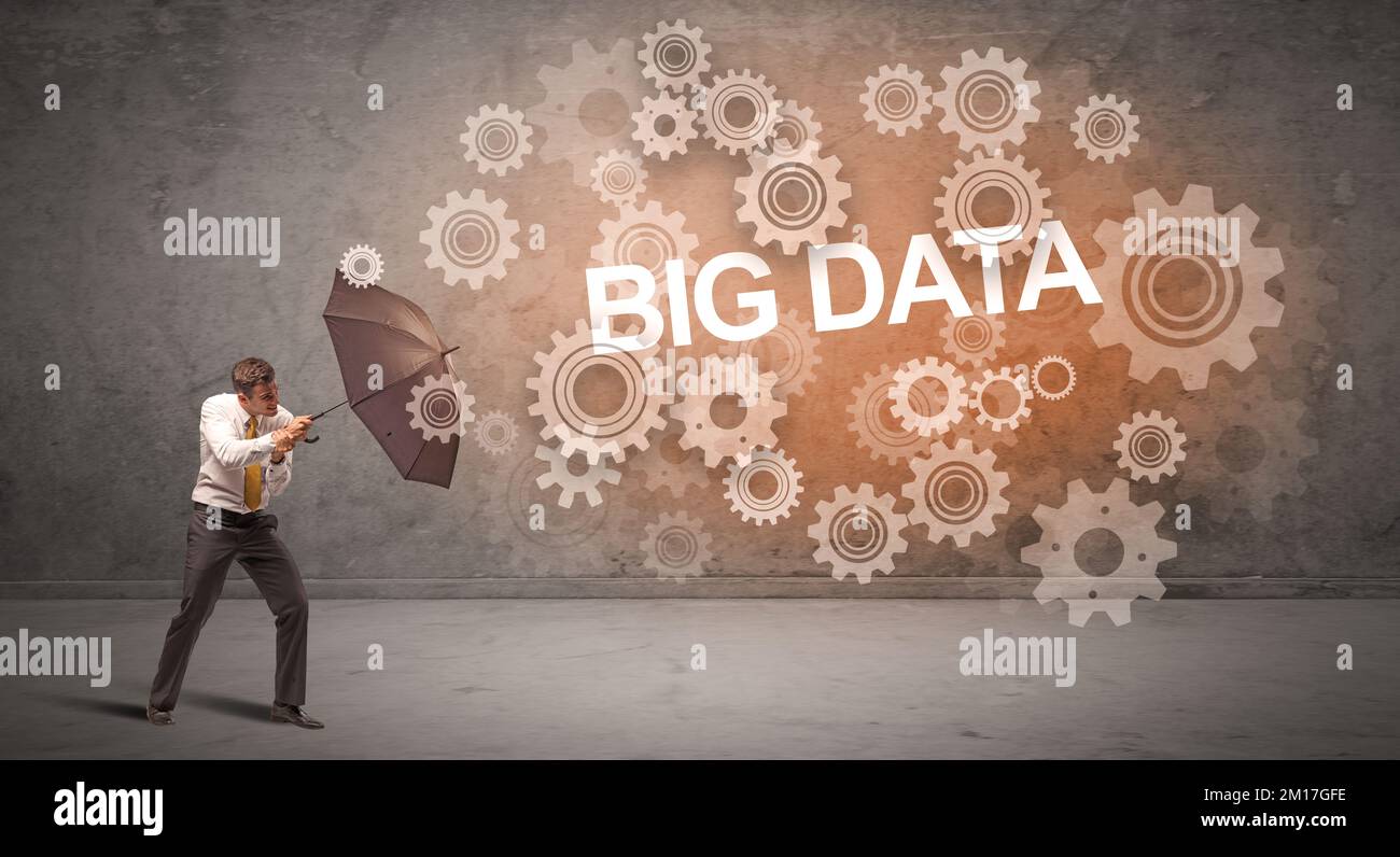 Businessman defending with umbrella concept Stock Photo - Alamy