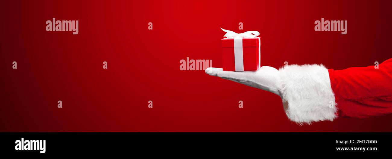 Santa holding a gift. Merry Christmas composition concept Stock Photo ...