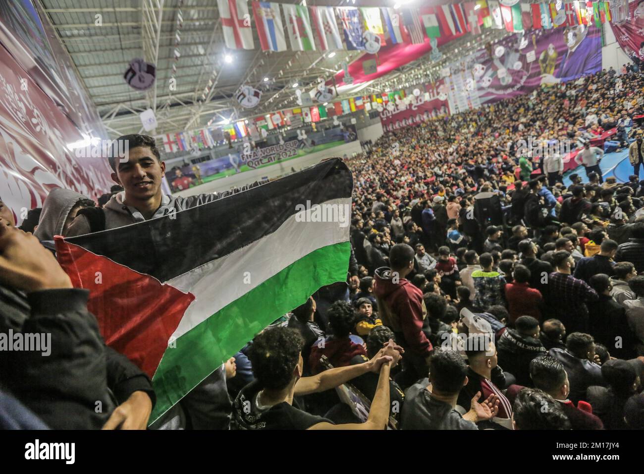 Gaza, Palestine. 10th Dec, 2022. Palestinians watch the live broadcast ...